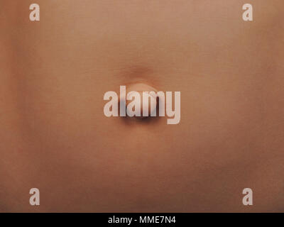 Navel. Close-up of the navel (belly button) of a woman. Also known as ...