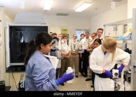 Two technicians at the Naval Research Laboratory (NRL) assemble a ...