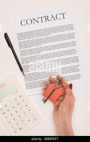 Hand holding an isolated paper house with a white background Stock ...