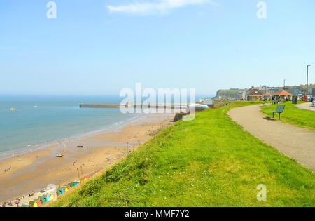Tourists on Whitby beach West Cliff in North Yorkshire Stock Photo - Alamy