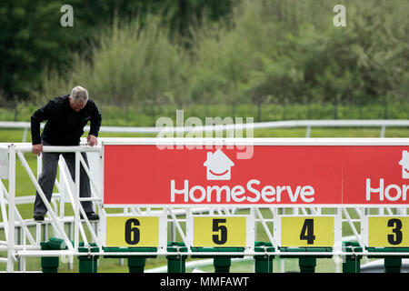 The starting stalls being checked and prepared for horse racing on the ...