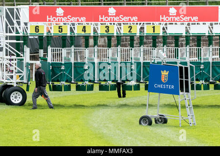 The starting stalls being checked and prepared for horse racing on the ...