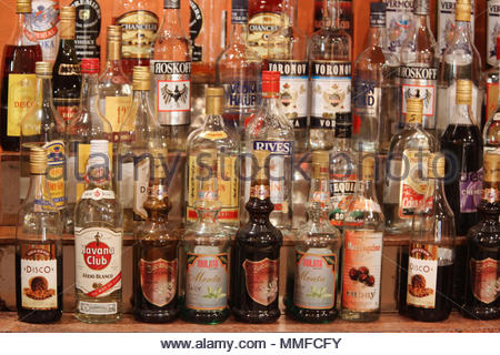Behind bar display of shelves with bottles of alcohol Stock Photo ...