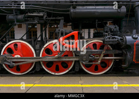 Closeup of the wheels, connecting rods and pistons of a steam ...