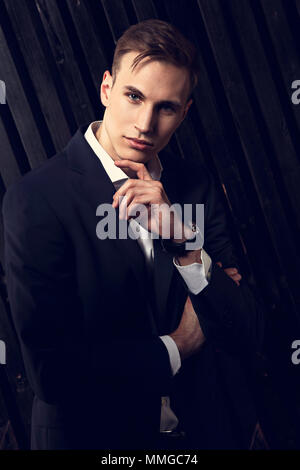 Confident handsome man with strained look posing in blue fashion suit ...