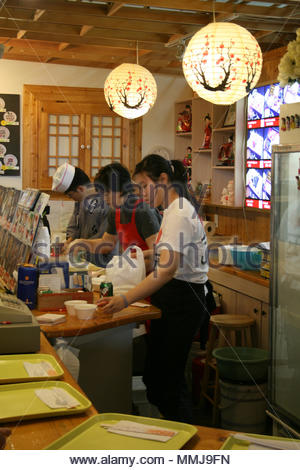 Cooks serving food inside a Japanese restaurant in Kyoto Japan Stock ...