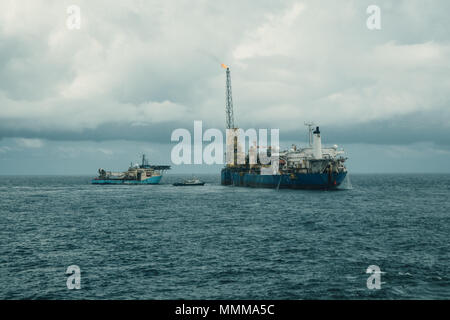 Oil rig support vessel approaching oil rig Stock Photo - Alamy