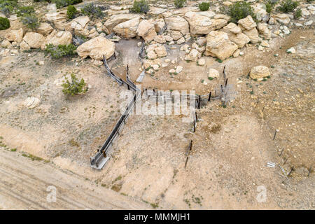 Aerial view of old abandoned sheep corral with a loading ramp on arocky ...