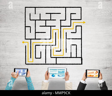 Labyrinth and business people working together, sorting problems ...