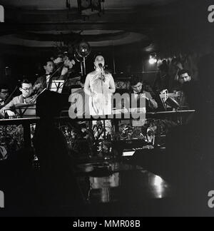 1950s, female japanese singer with band performing at a Tokyo nightclub ...