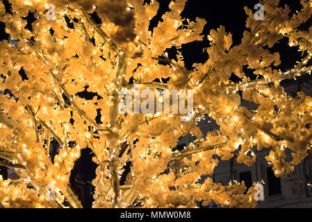 Christmas tree bulbs with yellow garlands covered snow, outdoor xmas ...