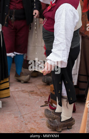 A man wearing traditional costume is pouring a bottle of cider Stock ...