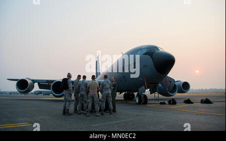Maintainers from 349th Aircraft Maintenance Squadron place covers over ...