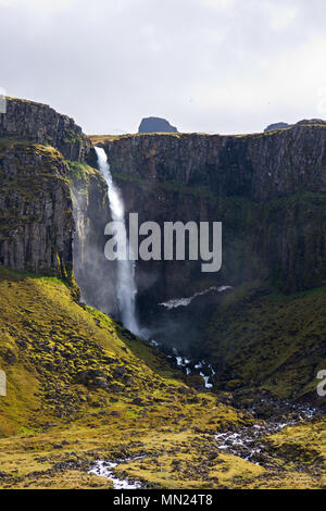 A tall waterfall in Iceland and a black mountain in Iceland Stock Photo ...