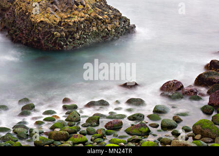 Basalt rocks and formations in different colors at the coast near ...