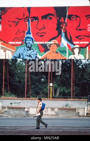 A pedestrian walks past a mural depicting 1920's film stars John ...