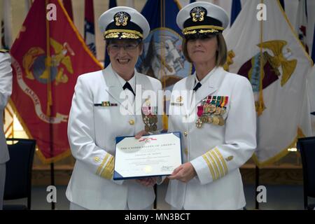 Rear Adm. Rebecca McCormick-Boyle is presented her personal flag by ...