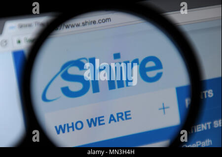 Shire Pharmaceutical company website seen through a magnifying glass ...