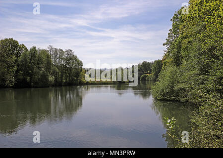A scenic view of a tranquil lake surrounded by beautiful autumn trees ...