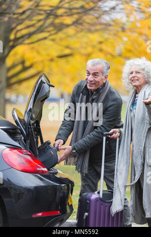 Smiling woman unloading car trunk with boxes Stock Photo - Alamy