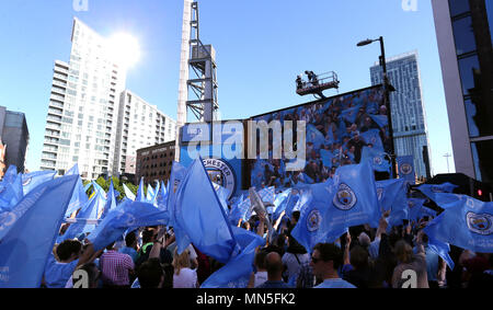 Manchester City fans wave flags ahead of kick-off near a banner that ...