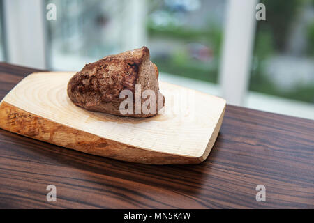 Cooked single rib beef ober wooden plate Stock Photo - Alamy