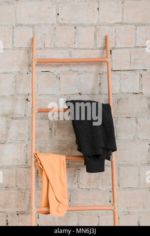 Ladder for clothes in a loft style of wood Stock Photo - Alamy