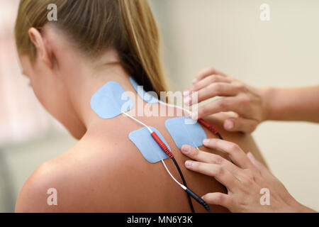 Electrical muscle stimulation in physical therapy. Therapist ...