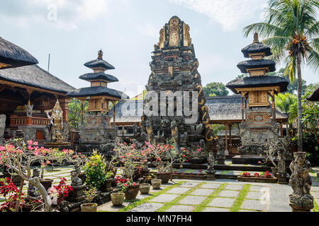 A padmasana shrine topped with a golden empty throne decorated with the ...