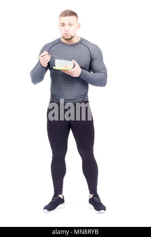 Portrait of male athlete eating spaghetti from plastic lunch box Stock ...