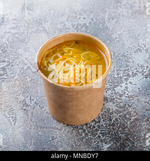 Chicken soup with noodles in a paper cup. Food delivery Stock Photo - Alamy