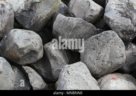 Grey rocks with different colour stones background Stock Photo - Alamy