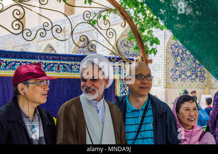 Shia Muslim mullah in turban and gown seated at prayer in the Masjed-e ...