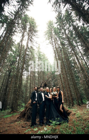 Smiling wedding couple with their friends Stock Photo - Alamy