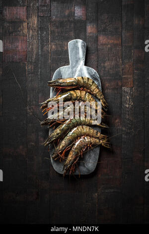 Row of uncooked fish on table Stock Photo - Alamy