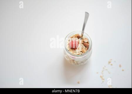 Honey and almond muesli with raspberries in a glass Stock Photo - Alamy