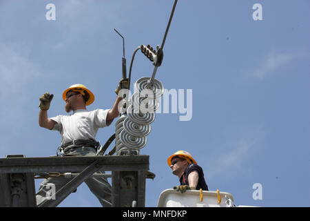 Utility workman installing updated components to a "city gate ...