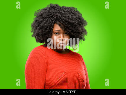 Beautiful african woman puffing out cheeks, having fun making funny ...