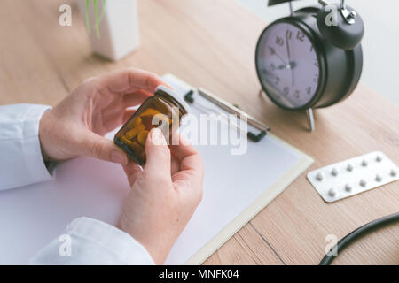 Female doctor holding unlabeled generic tablets and medication, generic ...