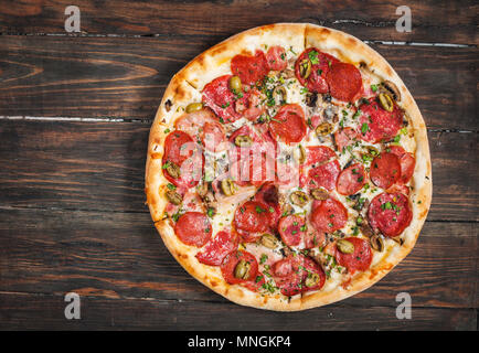 Pepperoni pizza on rustic, vintage style wood background. Top view ...