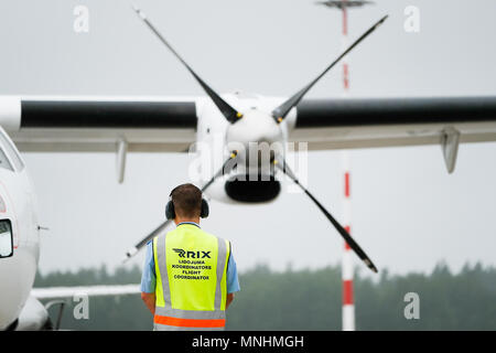 A flight coordinator is watching an airplane as it prepares for take ...