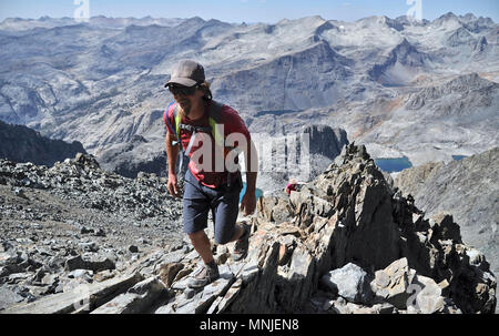 Backpackers climbing Mt Ritter on trek of Sierra High Route in Minarets ...