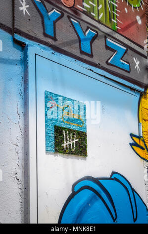Mosaic graffiti by street artist Mark Tally displayed on the walls of ...