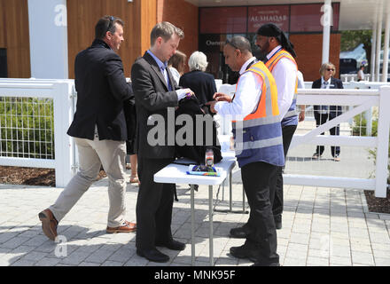 Security check the personal items of racegoers at Newbury Racecourse ...