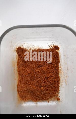 Chili powder in a glass jar with closed lid. Isolated on white ...