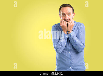 Handsome middle age man terrified and nervous expressing anxiety and ...