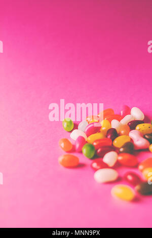 top view of colorful pills and jelly capsules on yellow background ...