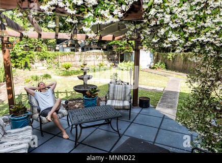 Man lying down in his deck chair Stock Photo - Alamy