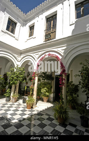 A large Spanish inner courtyard with Moorish architectural arches in a ...