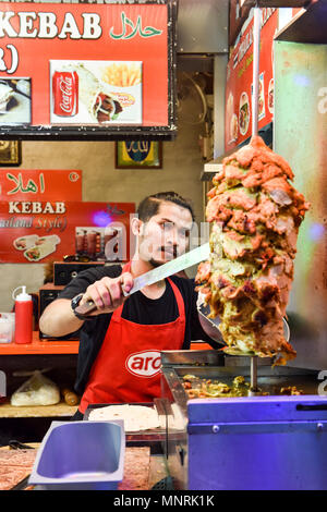 Shawarma street food counter. Meat frying on pole, while cooking. Kuala ...